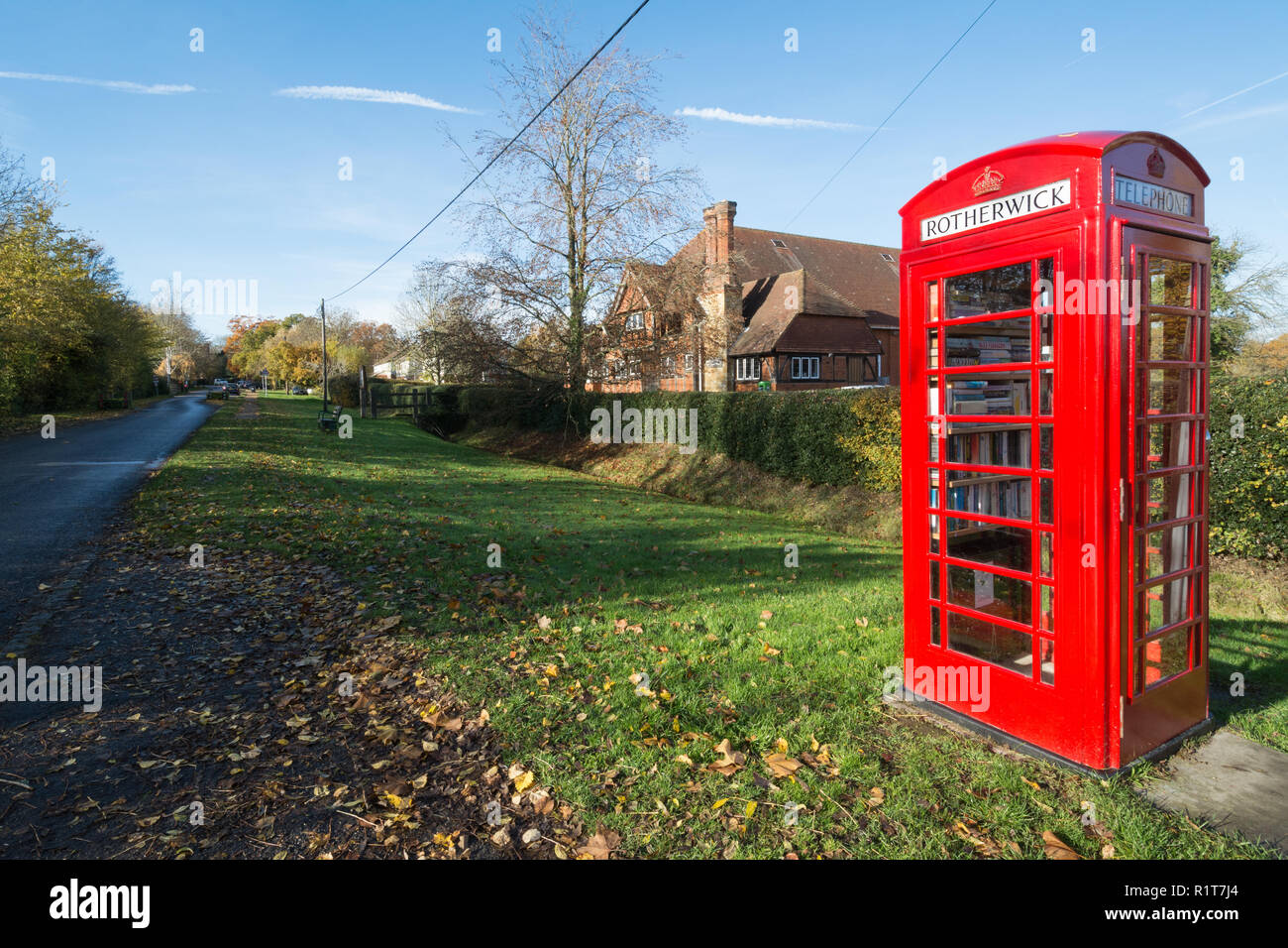Old-fashioned red telephone box or kiosk on The Street near the village ...