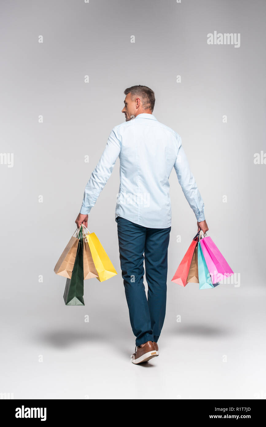 Man carrying shopping bags hi-res stock photography and images - Alamy
