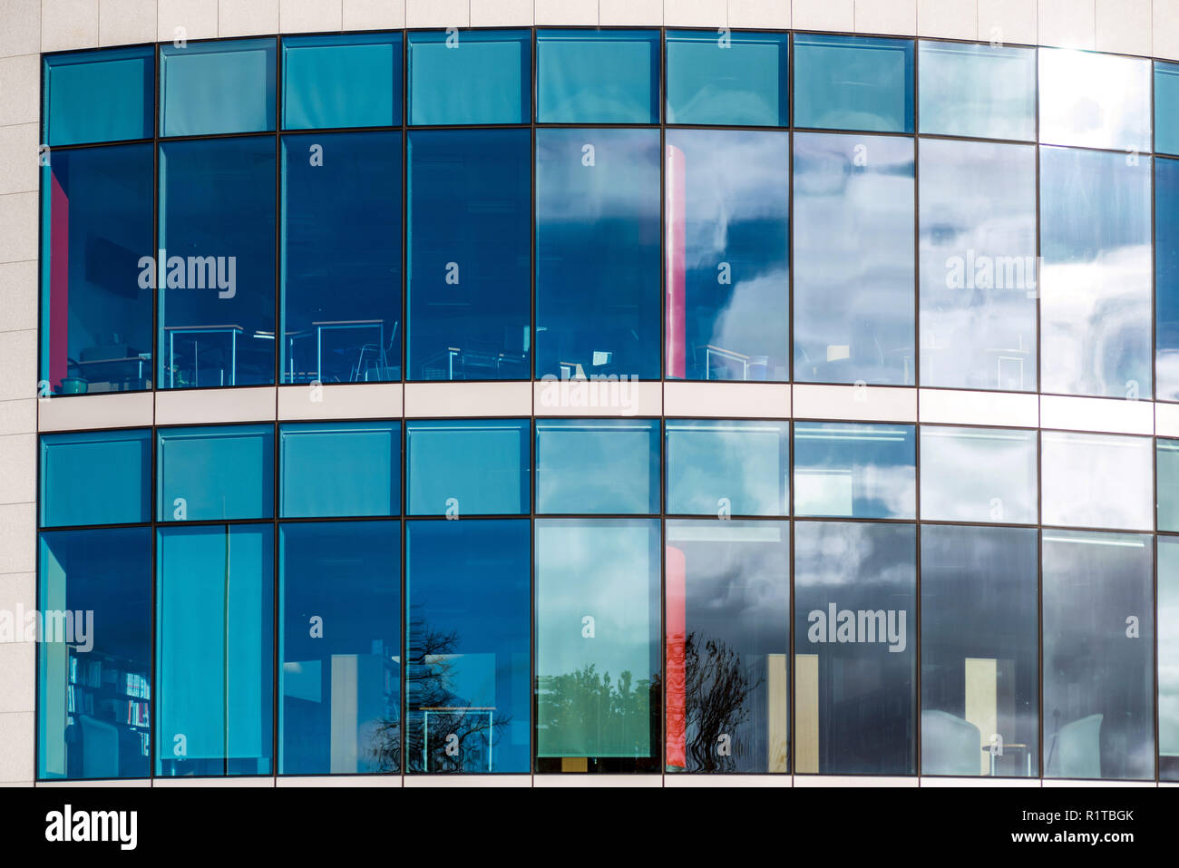 sunny day view of windows of modern business corporate office building ...