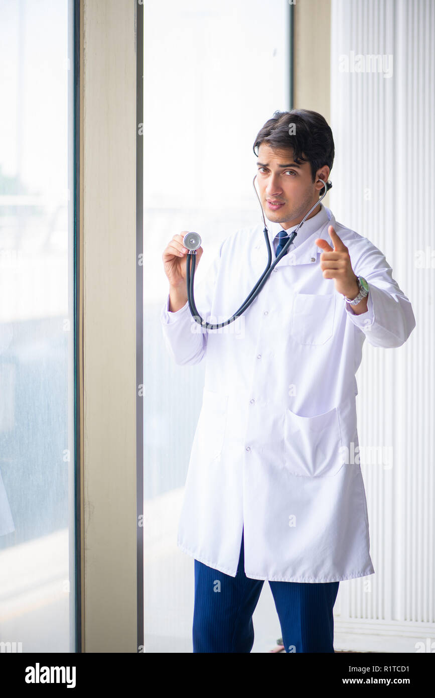 Young handsome doctor standing at the window Stock Photo - Alamy