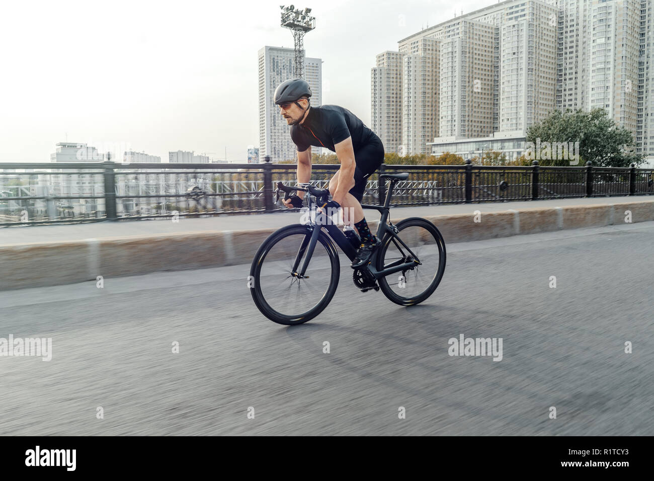 Athletic sportsman riding professional bike in race on a road Stock ...