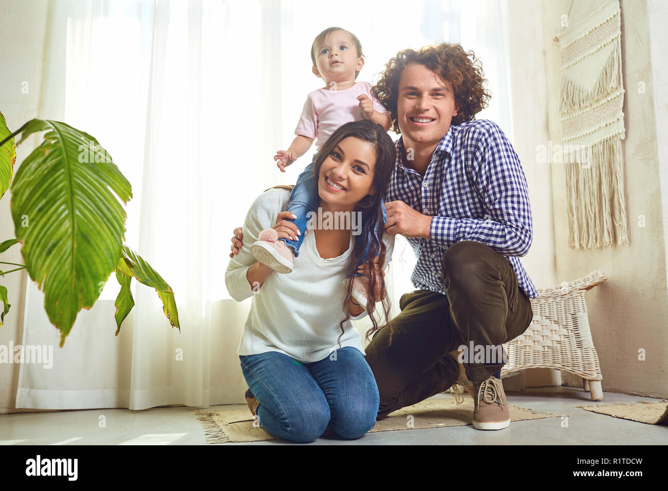 Happy family playing with baby at home Stock Photo - Alamy