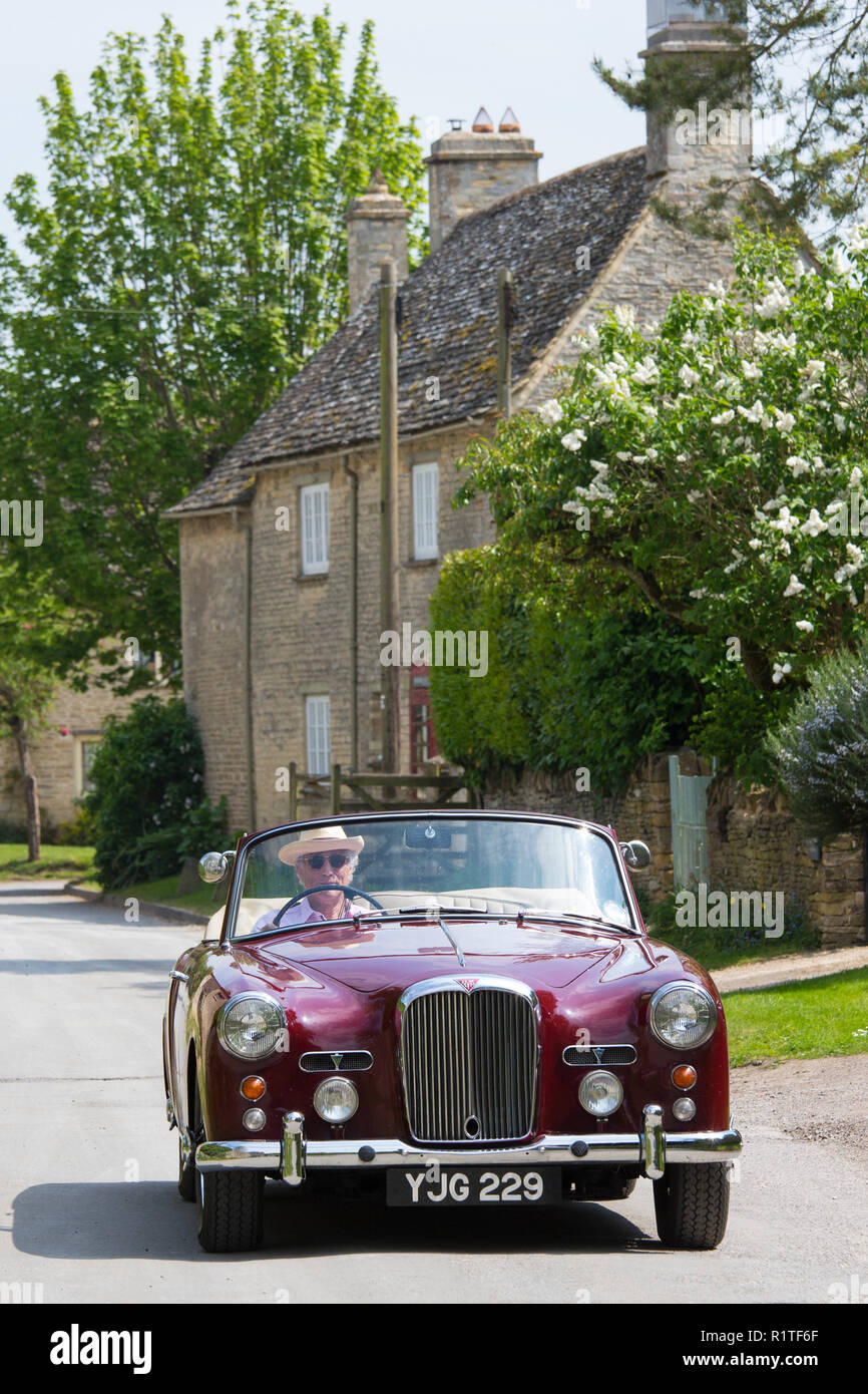 Motorist driving 1961 British made Alvis TD21 Series 1 drophead ooupe ...