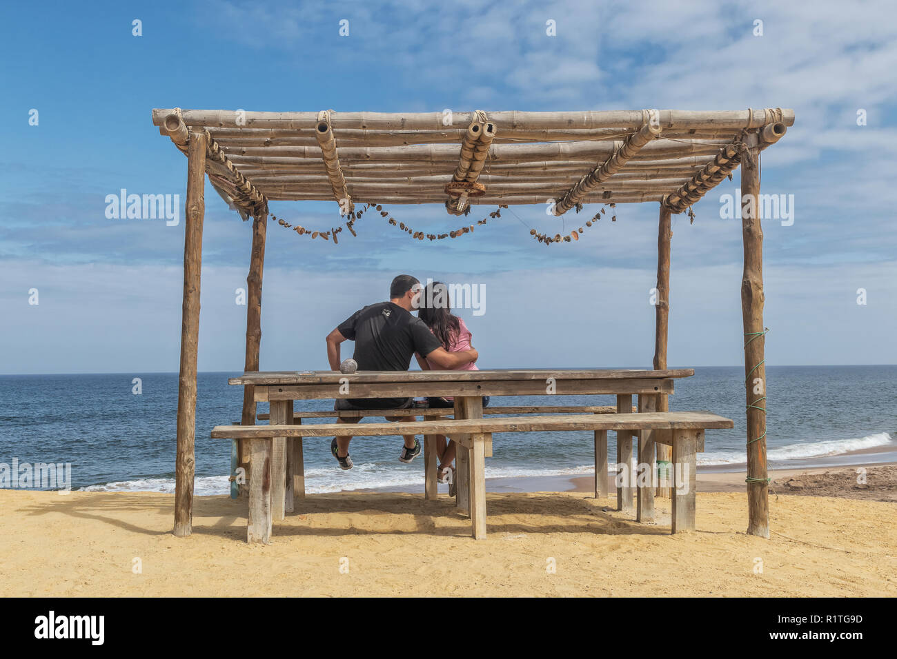 NAMIBE/ANGOLA 02NOV2018 - Couple sitting on wooden porch overlooking ...