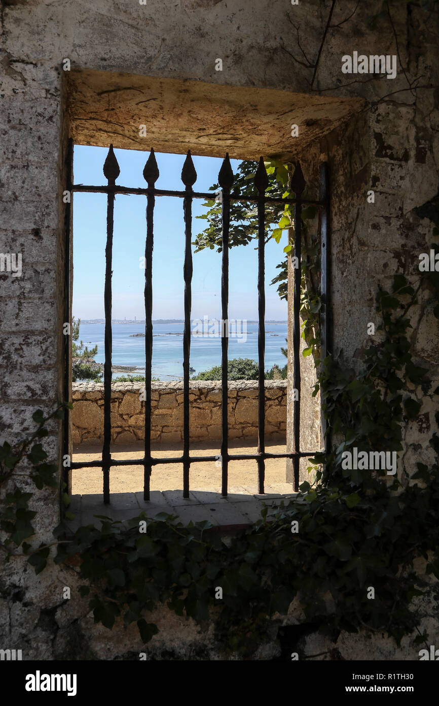 Metal bars overlooking Herm Island from St Tugals Chapel on Herm Island, Channel Islands, UK ...