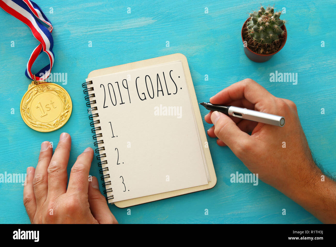 Top view 2019 goals list with notebook over wooden desk Stock Photo - Alamy