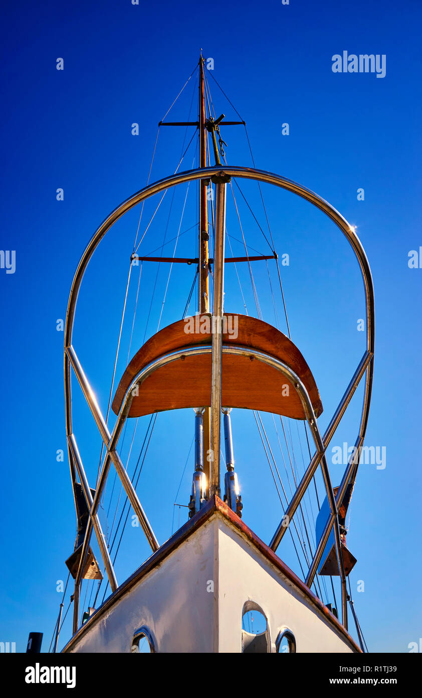 Boat bow with railing of sailboat under blue sky with anchor chain and ...