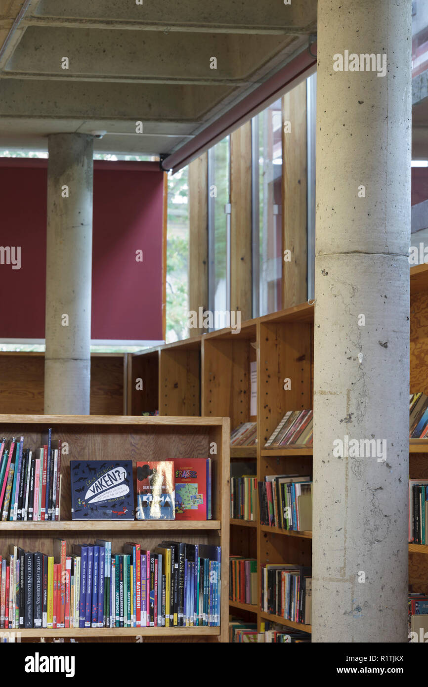 Cylindrical concrete pillars with wooden bookshelves. Deichman Library ...