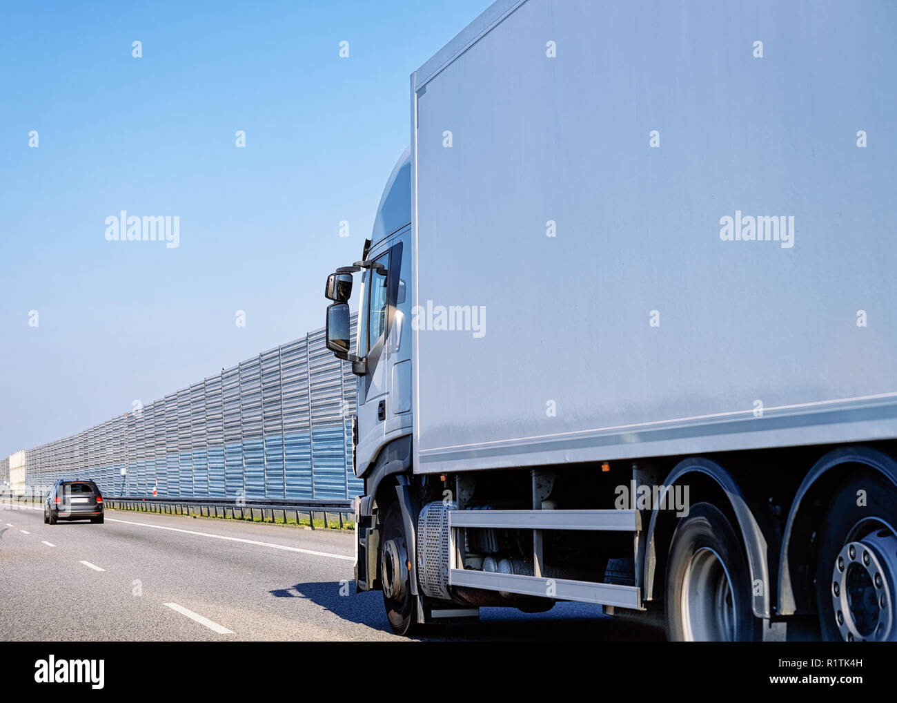 White Truck in the asphalt road of Poland. Lorry transport delivering ...