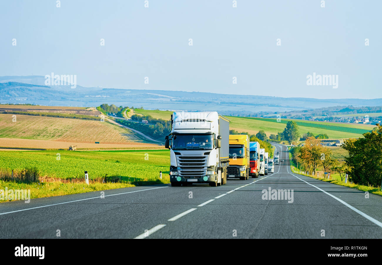 Trucks in the asphalt road in Poland. Lorry transport delivering some ...