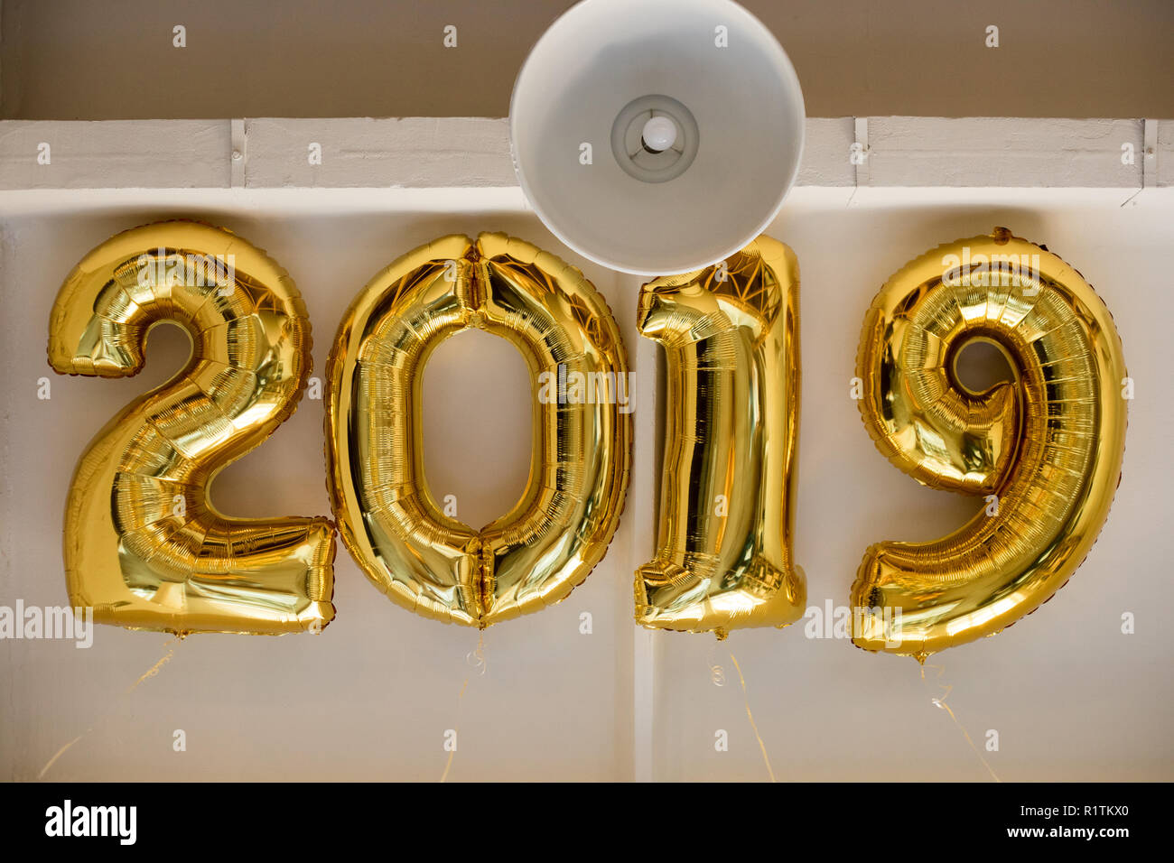 Sign 2019 made of golden balloons for new year on the white ceiling ...