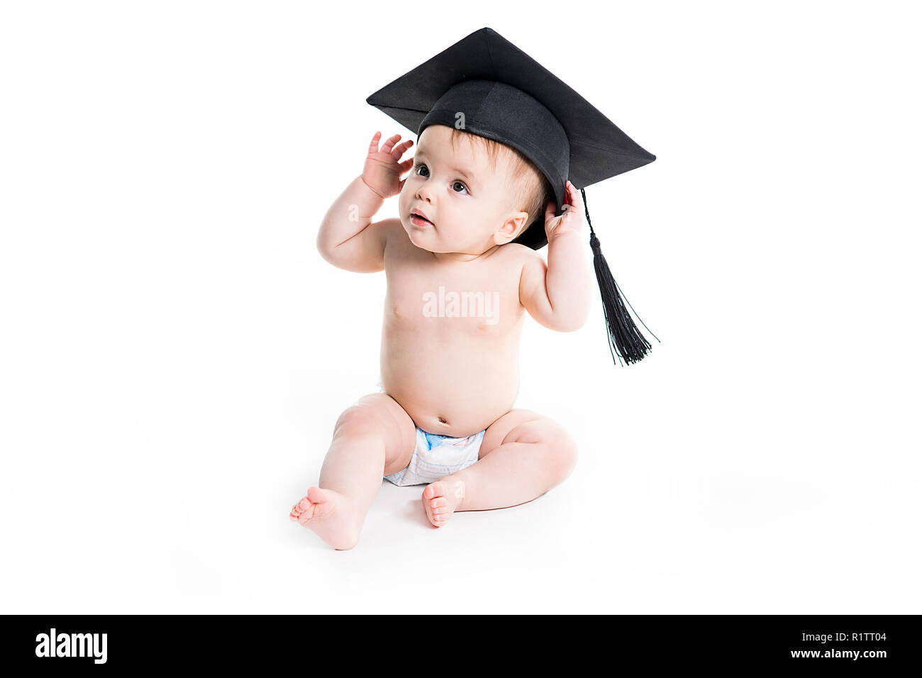 A Portrait of a sitting baby girl with a graduation cap Stock Photo - Alamy