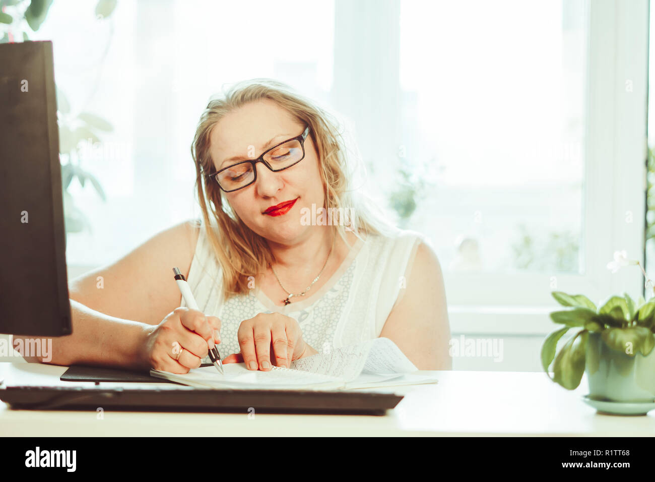 Mature woman writes notes hi-res stock photography and images - Alamy