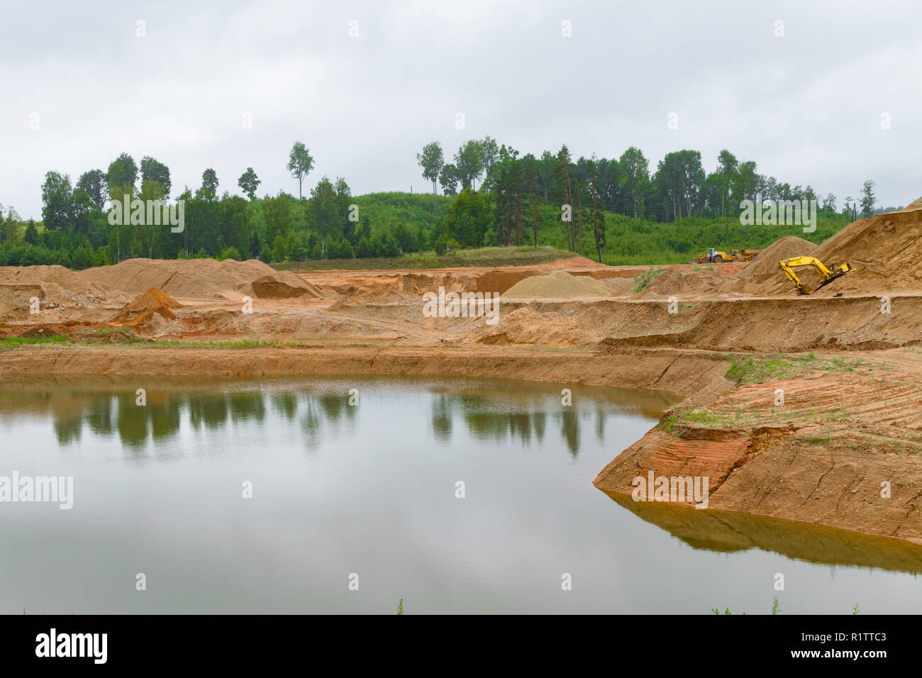 excavator working on sandpit earthmoving, sand quarry with water Stock ...