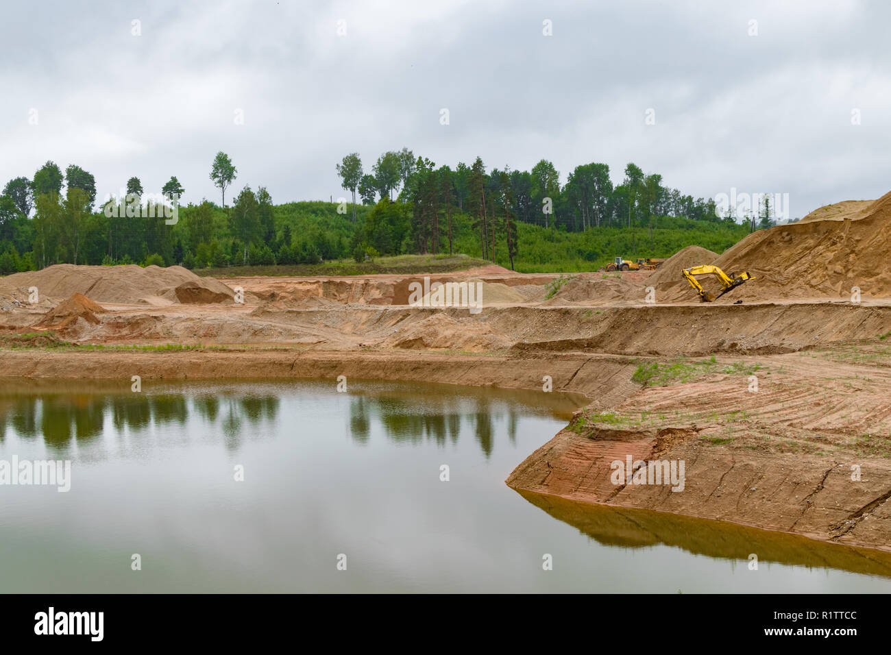 excavator working on sandpit earthmoving, sand quarry with water Stock ...