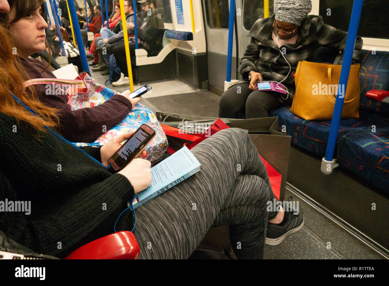 Tube commuters time, commuters reading and using smartphones on the ...