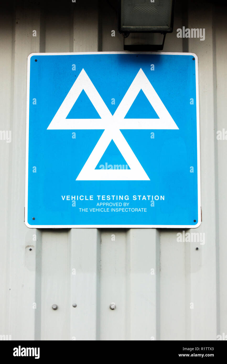 Blue Vehicle Testing Station sign on the outside wall of a service ...