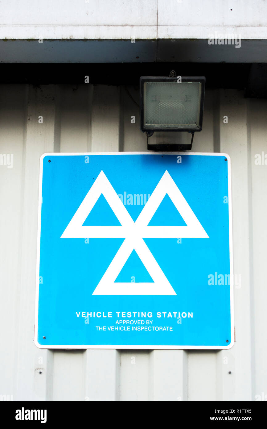 Blue Vehicle Testing Station sign on the outside wall of a service ...