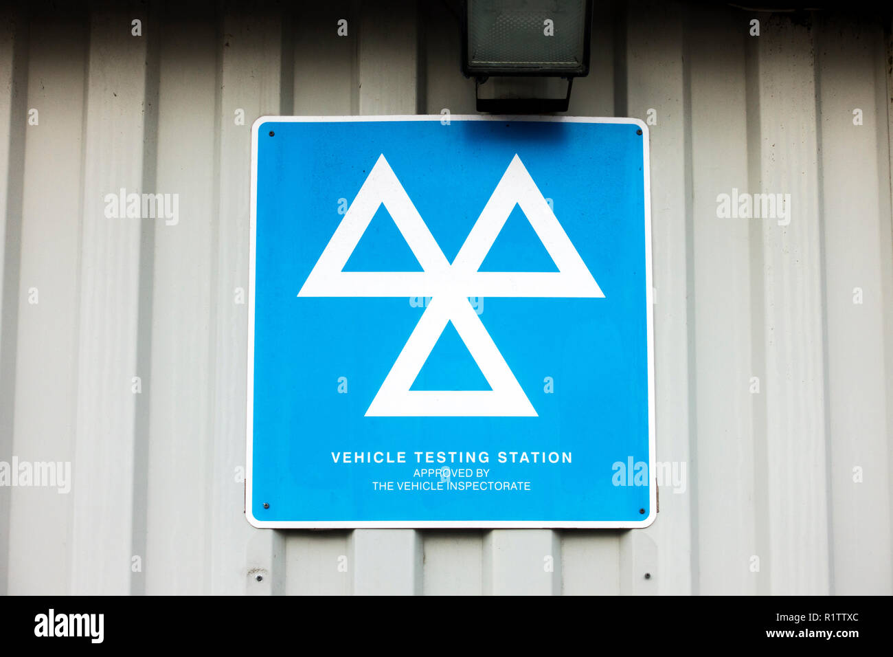 Blue Vehicle Testing Station sign on the outside wall of a service ...