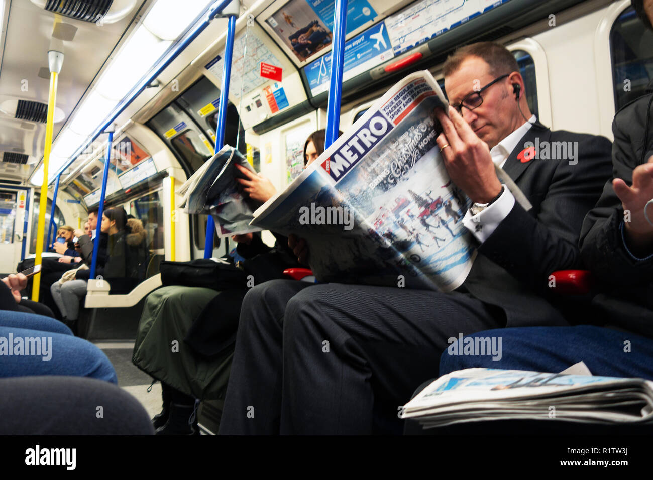 Tube commuters time, commuters reading on the London Underground Tube ...