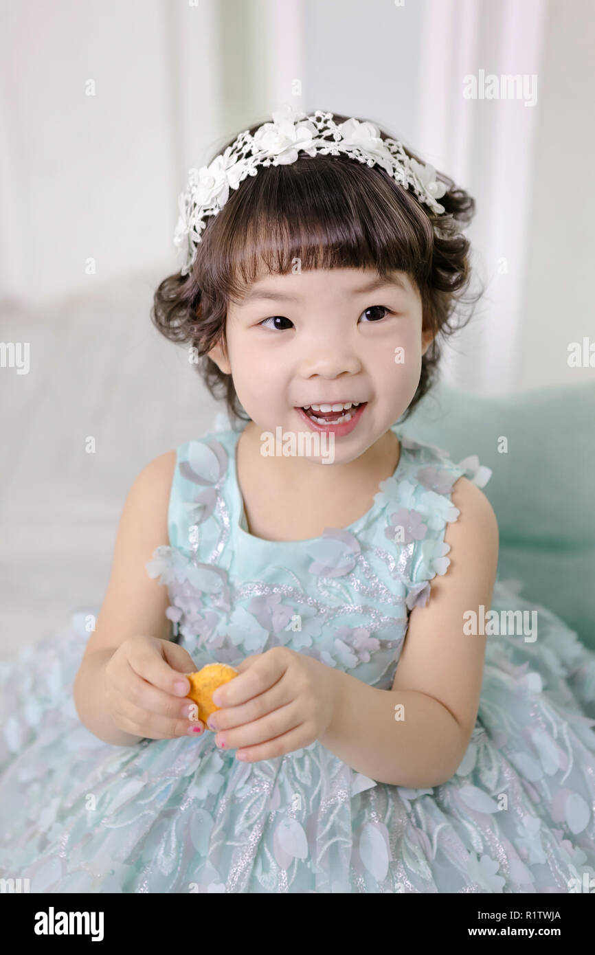 Little pretty Asian girl dressing as princess laughing portrait ...