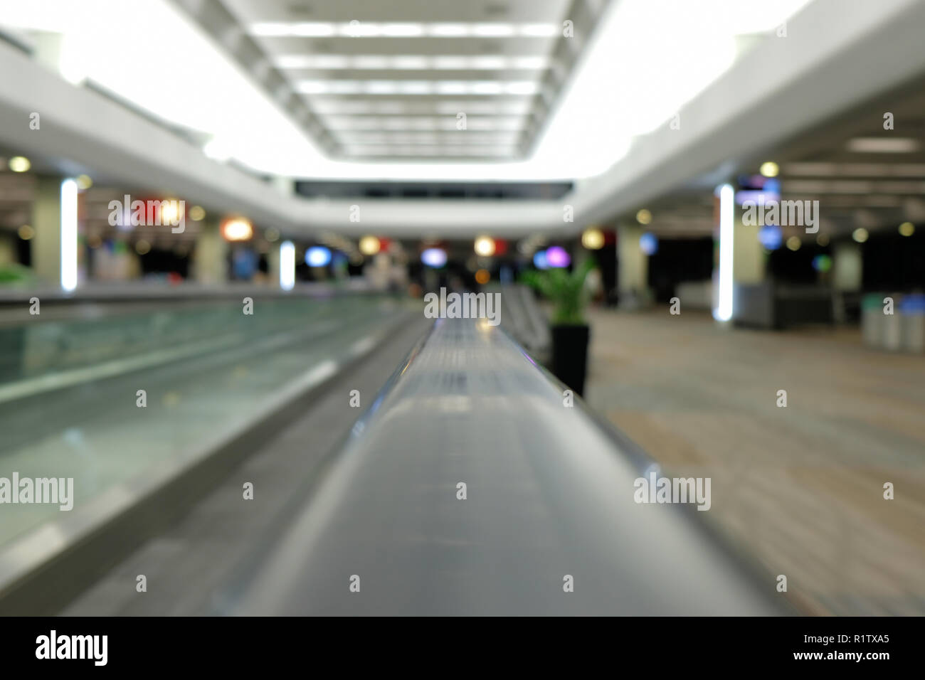 View of the handrail on an empty moving walkway at an airport ...