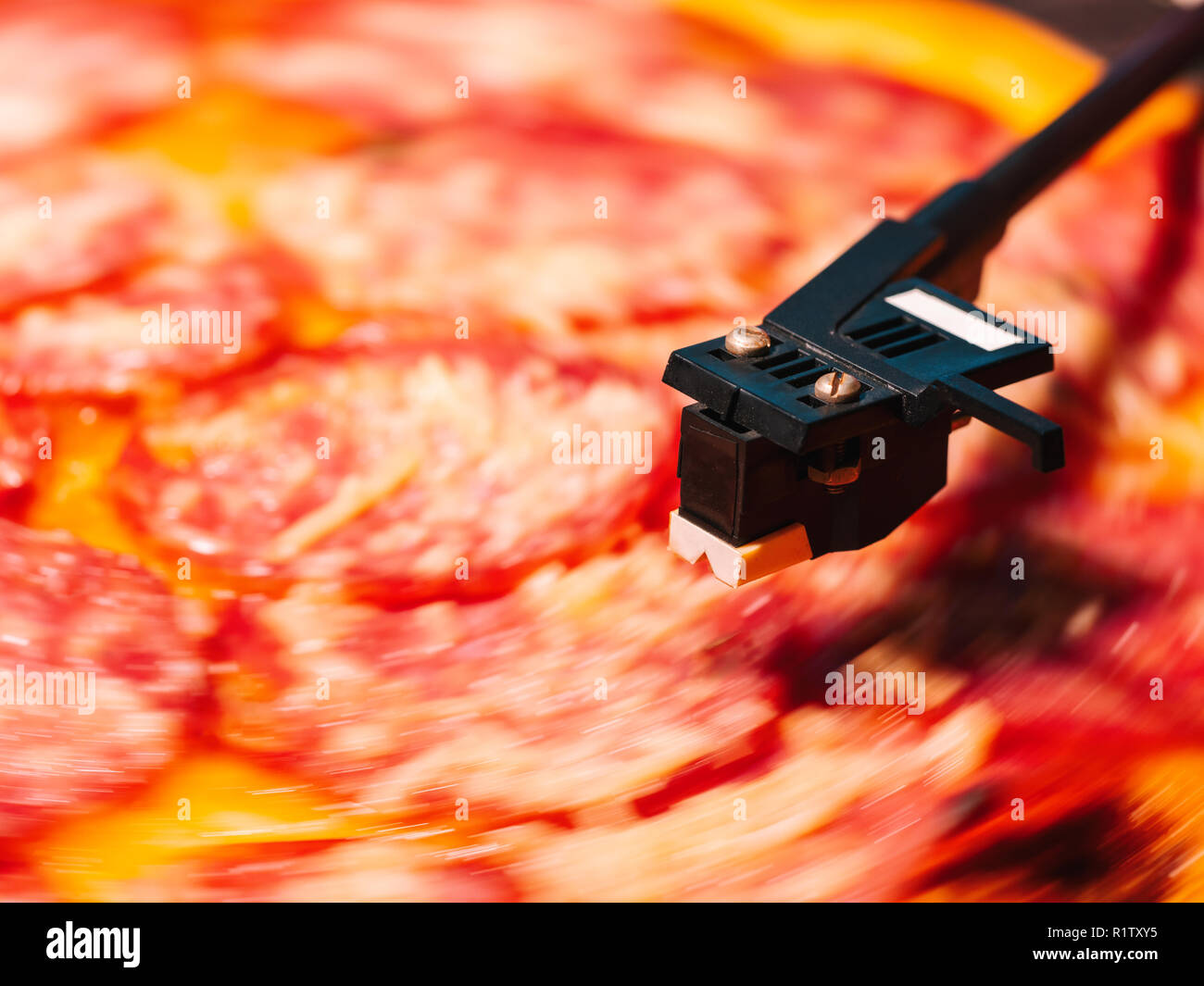 Pizza pepperoni spinning on turntable vinyl player. Concept of party ...