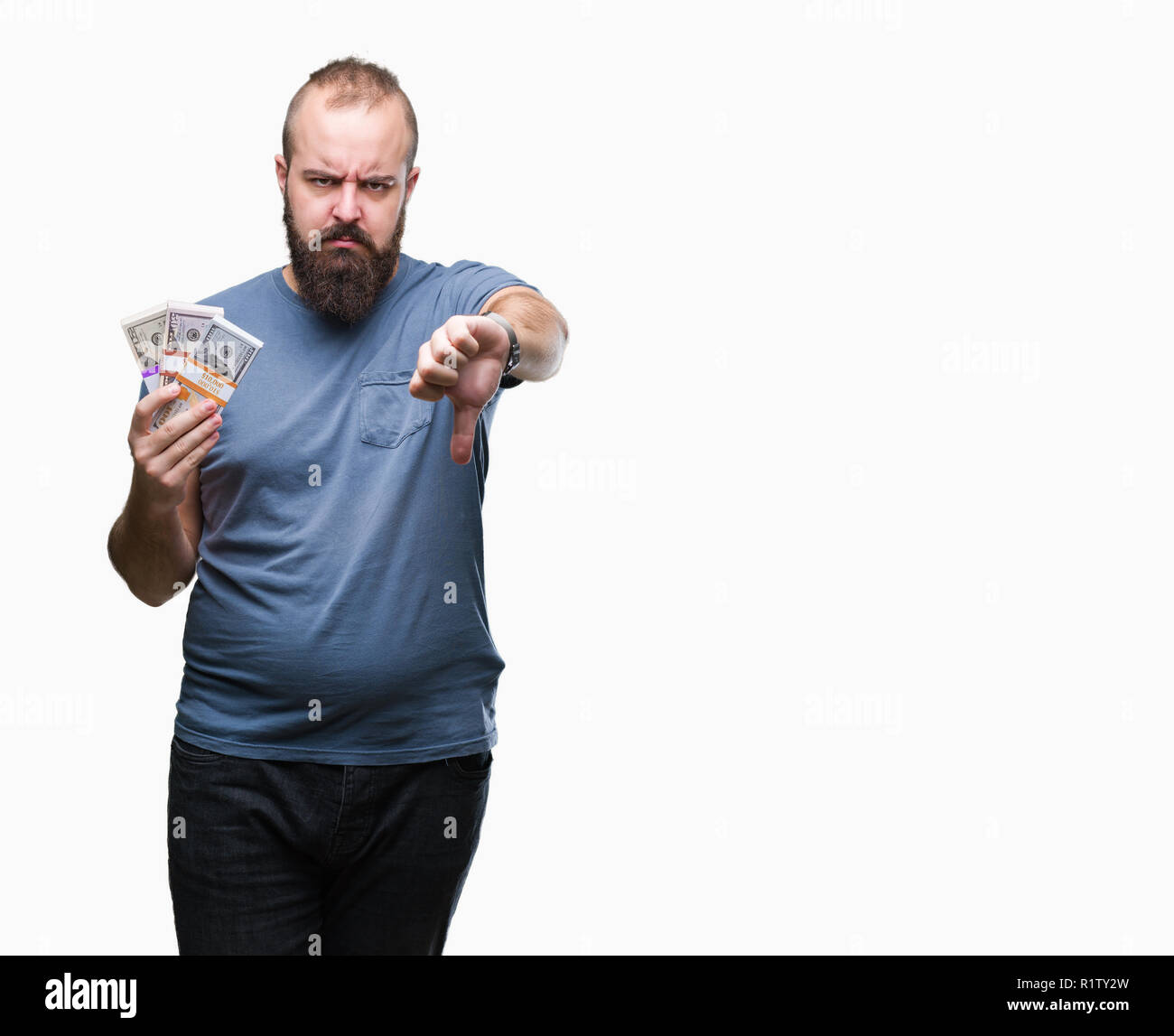Young hipster man holding bunch of money over isolated background with ...