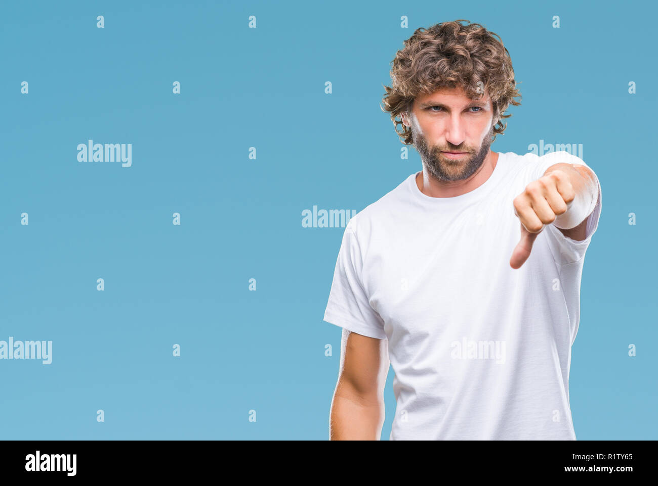Handsome hispanic model man over isolated background looking unhappy ...