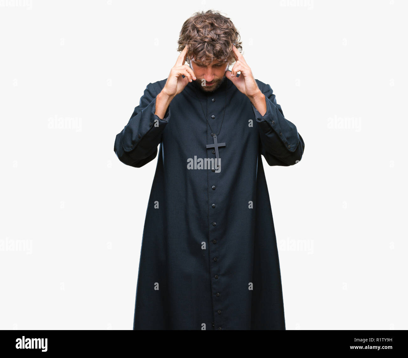 Handsome hispanic catholic priest man over isolated background with ...