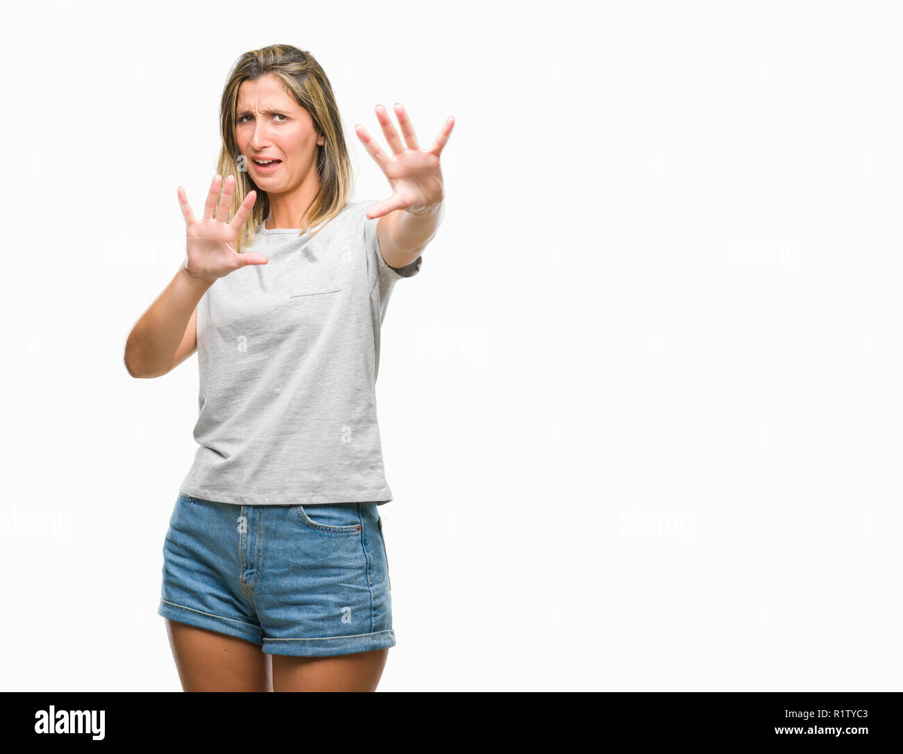 Young beautiful woman over isolated background afraid and terrified ...
