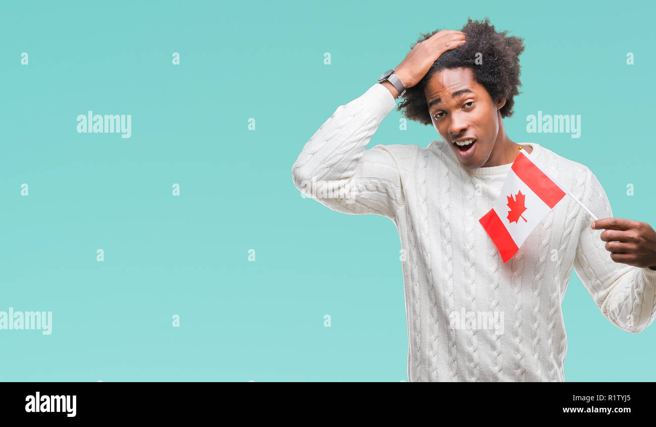 Afro american man flag of Canada over isolated background stressed with ...