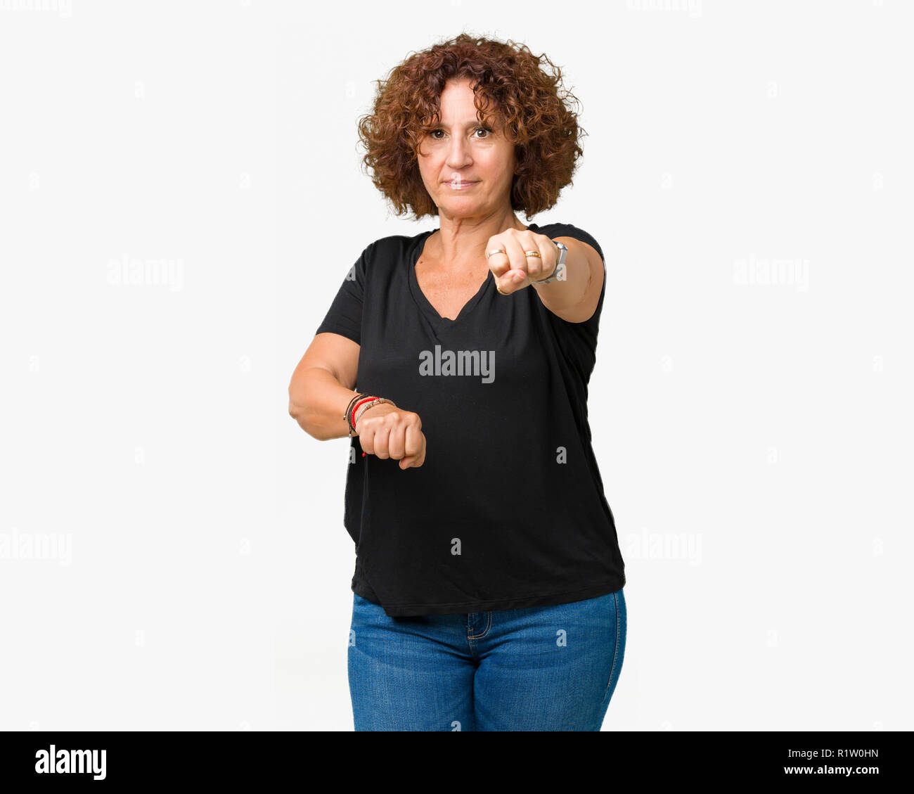 Beautiful middle ager senior woman over isolated background Punching ...