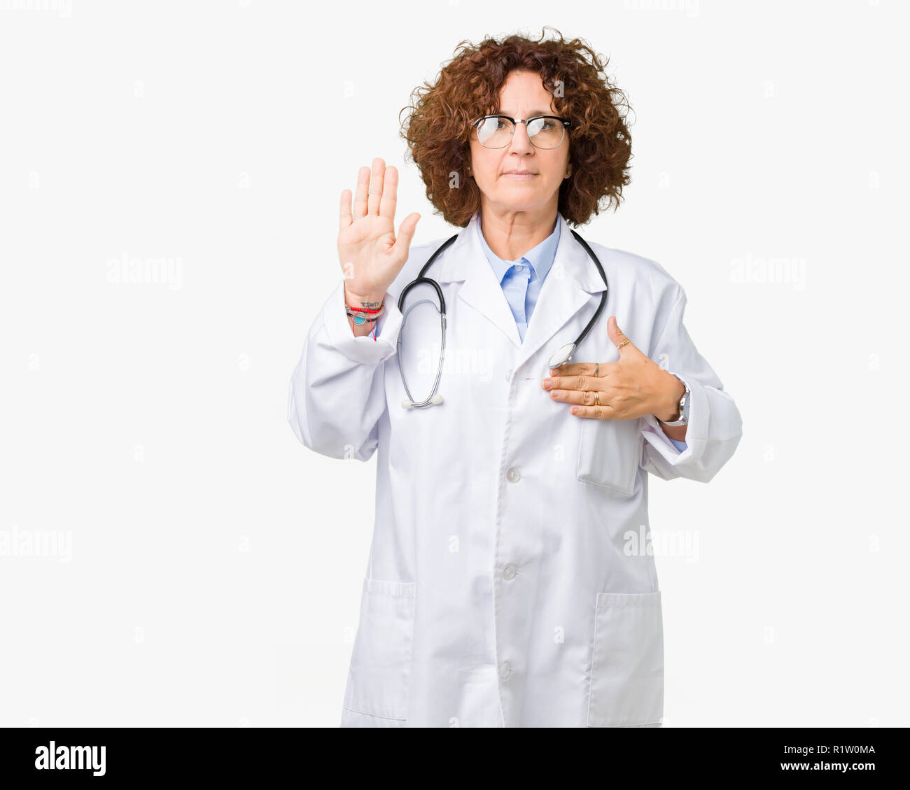Middle ager senior doctor woman over isolated background Swearing with ...