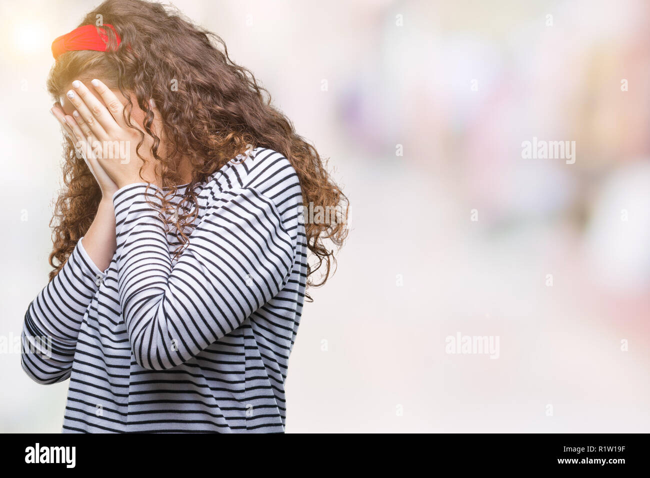 Beautiful brunette curly hair young girl wearing stripes sweater over ...