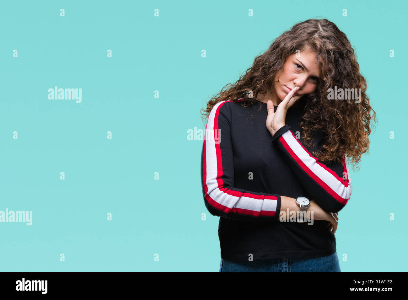 Beautiful young brunette curly hair girl wearing casual look over ...