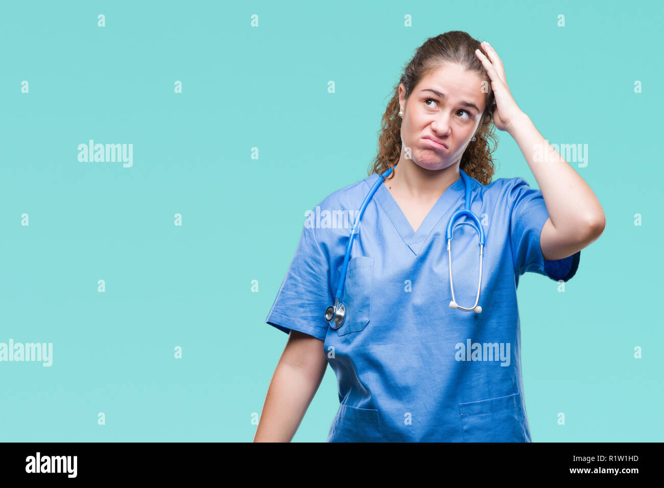Young brunette doctor girl wearing nurse or surgeon uniform over ...