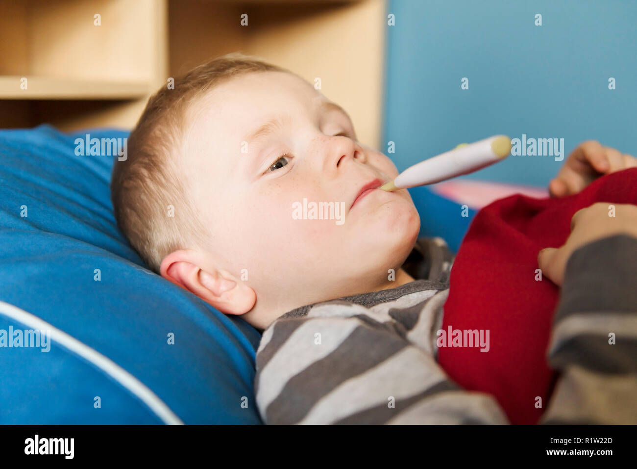 A child sick in bed sleeping and testing fever Stock Photo - Alamy
