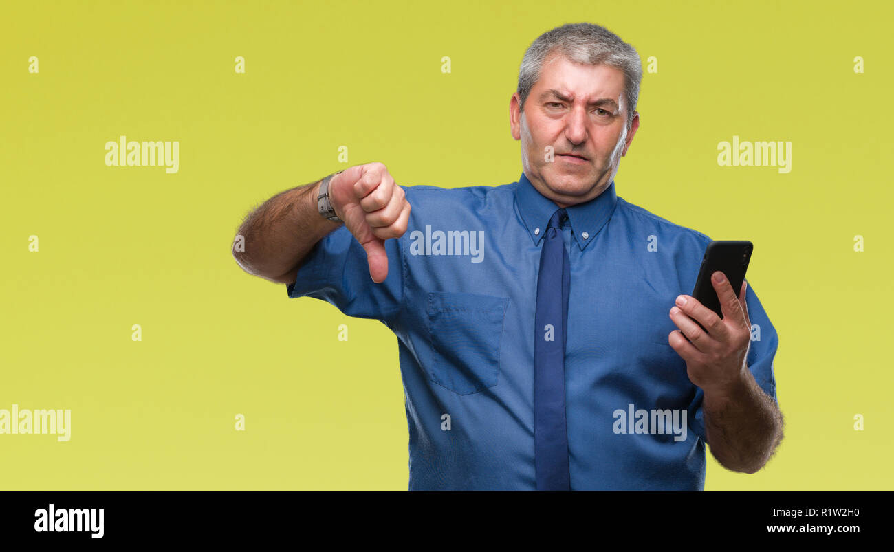 Handsome senior man texting sending message using smartphone over ...