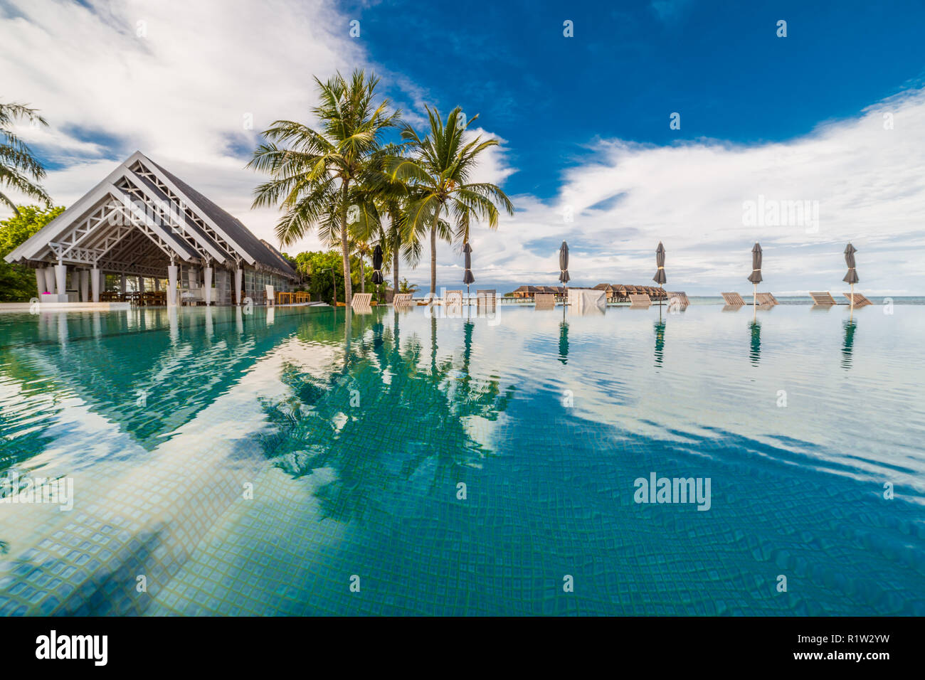 Luxury swimming pool in tropical resort, beach landscape, villa and ...