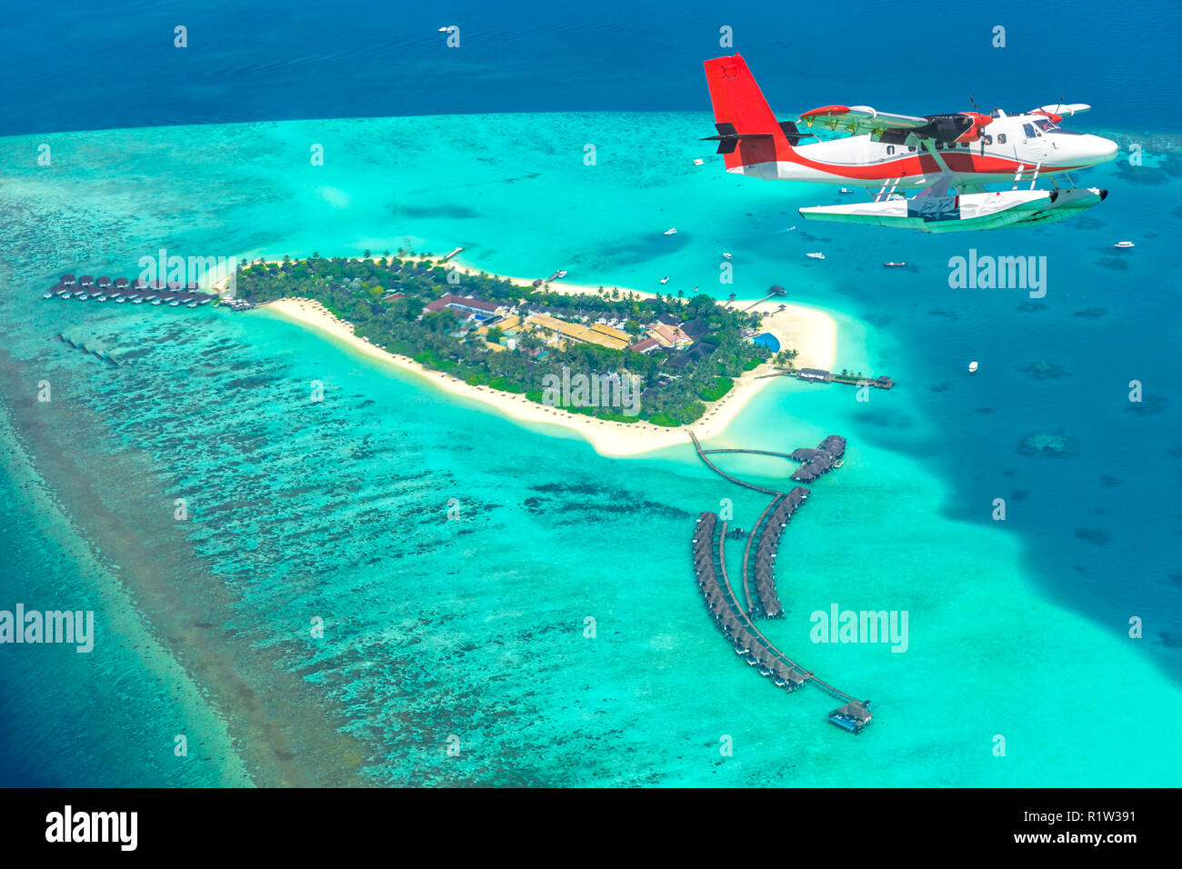Aerial view of a seaplane approaching island in the Maldives. Maldives ...