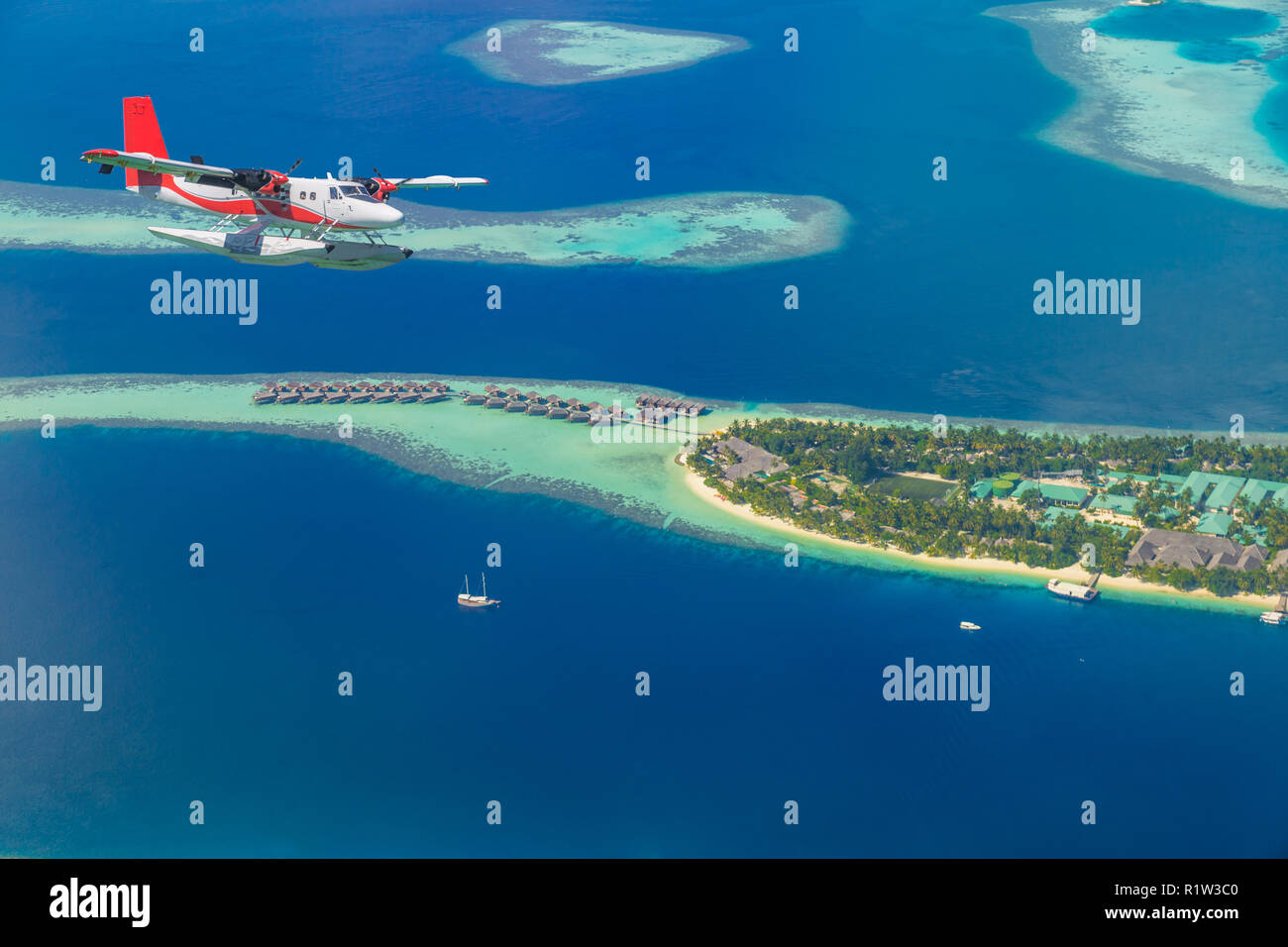 Aerial view of a seaplane approaching island in the Maldives. Maldives ...