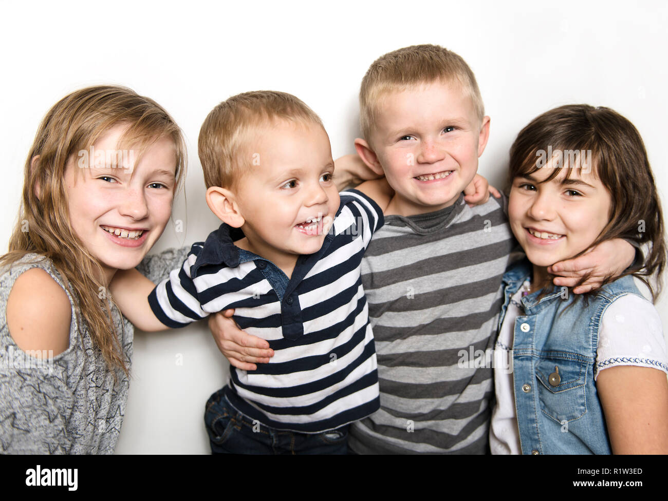 Childhood, love, happiness and family bonds. Indoor portrait of four ...
