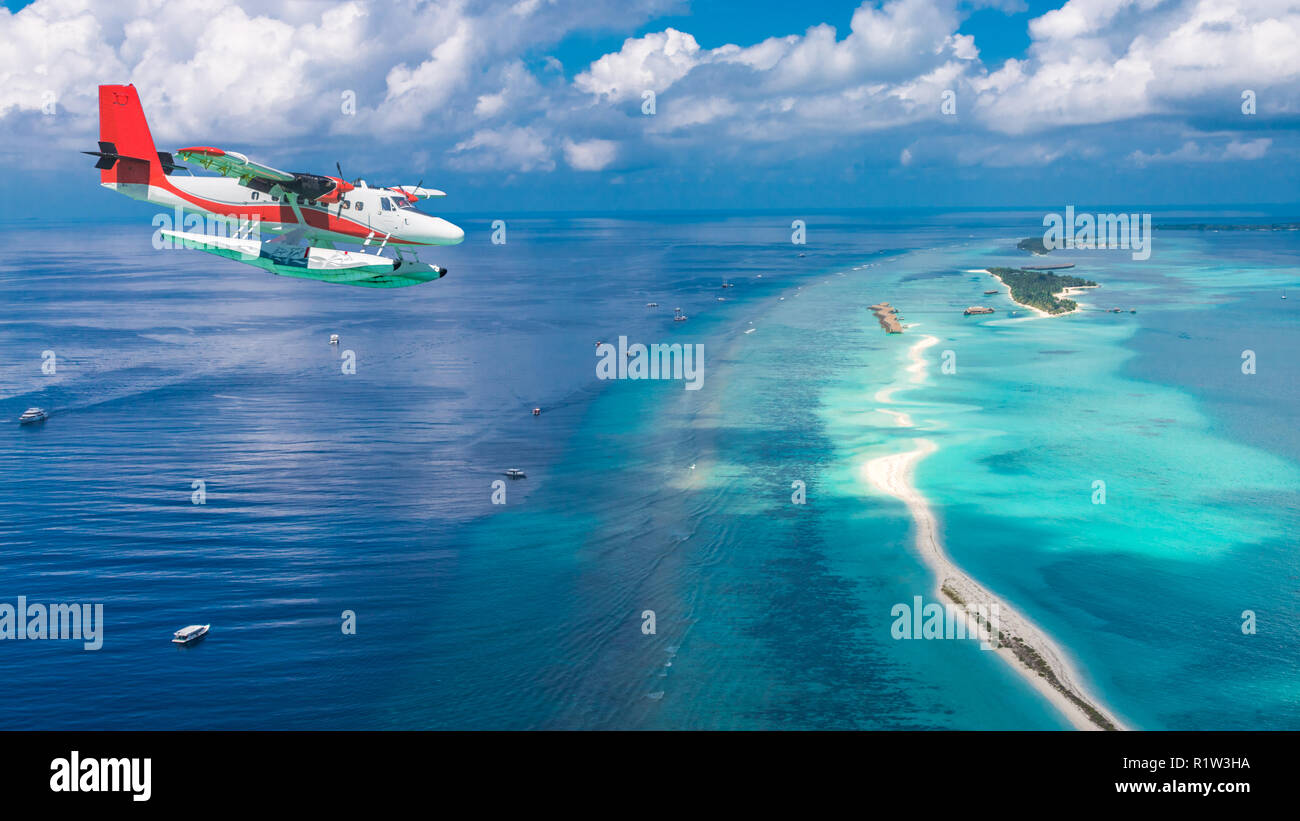 Aerial view of a seaplane approaching island in the Maldives. Maldives ...
