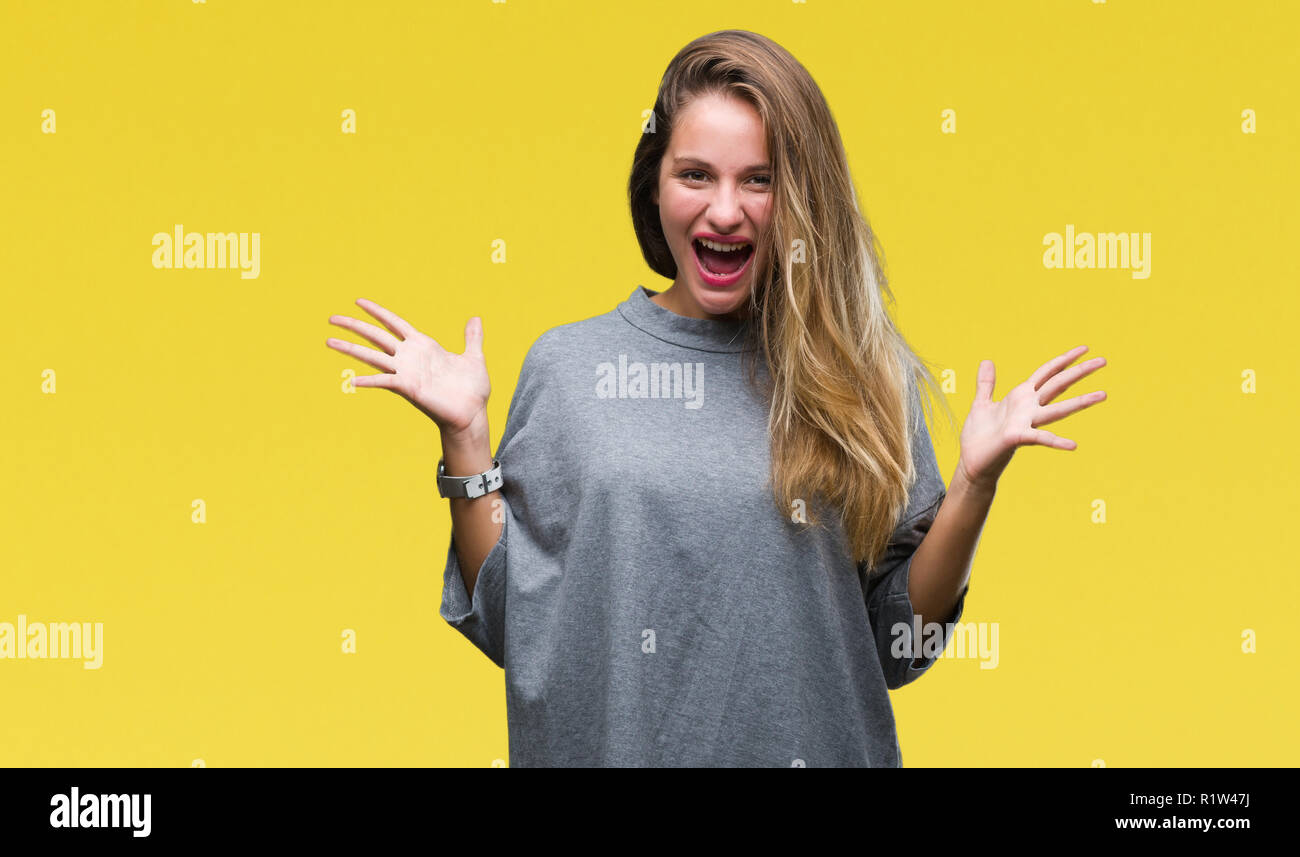 Young beautiful blonde woman over isolated background celebrating crazy ...