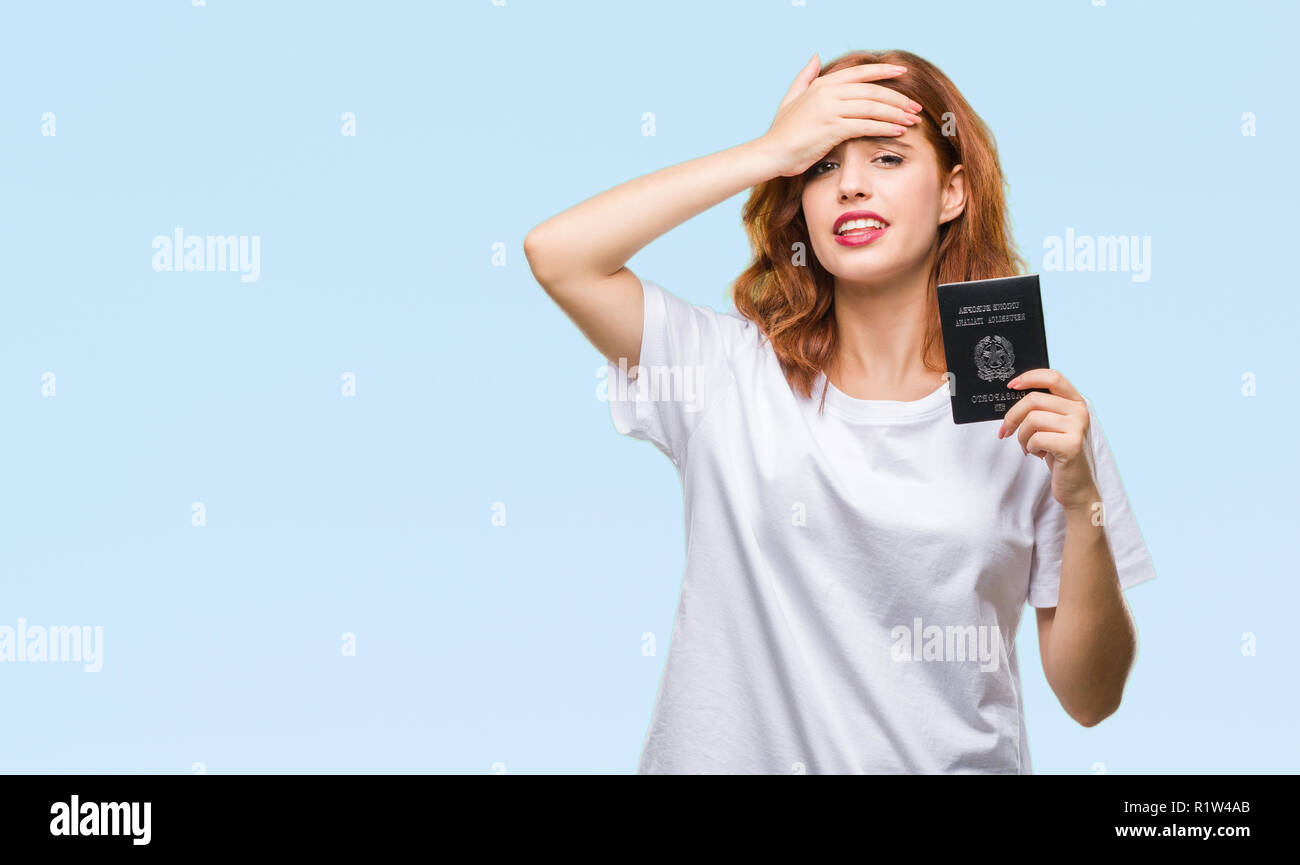 Young beautiful woman holding passport of italy over isolated ...