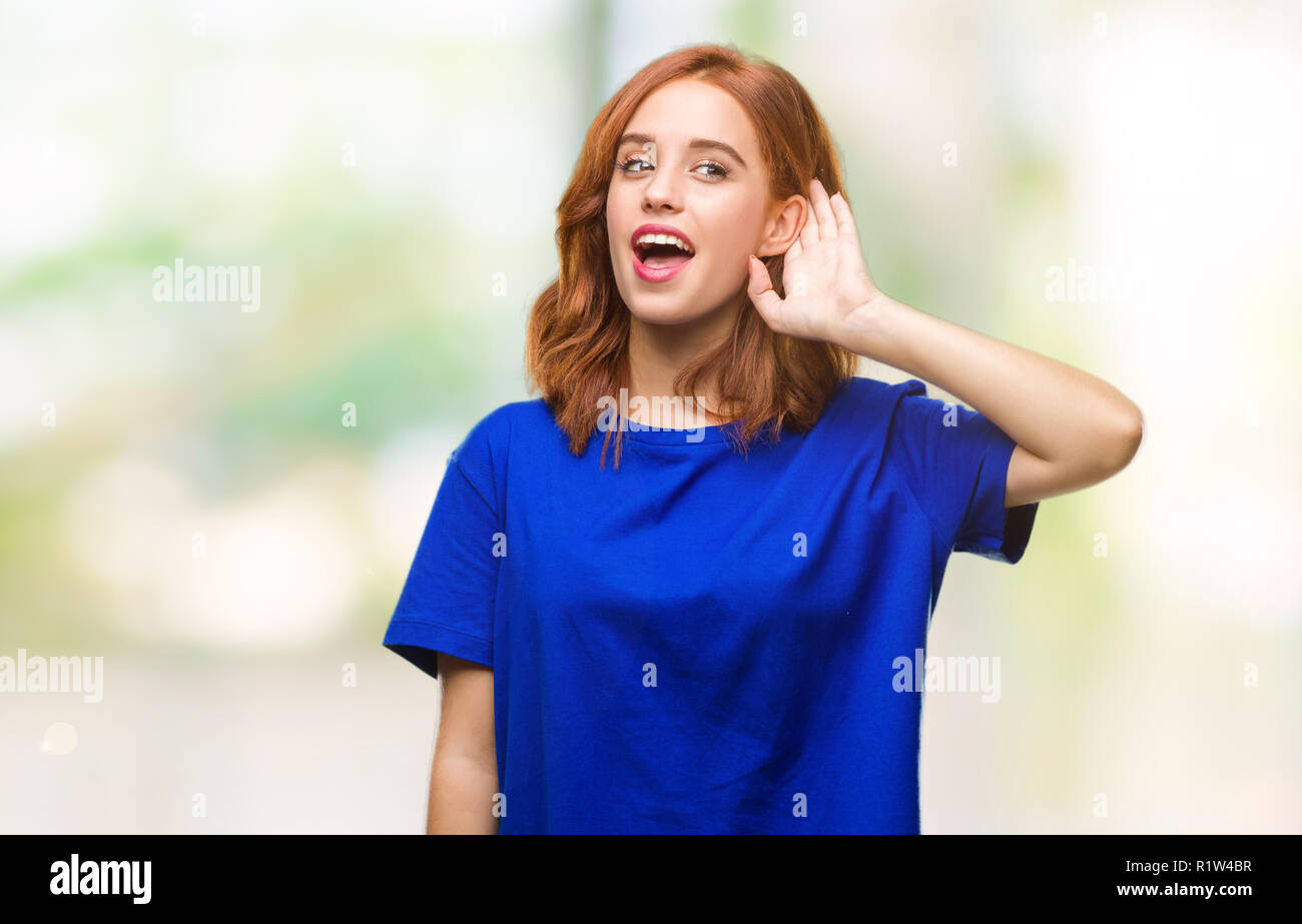 Young beautiful woman over isolated background smiling with hand over ...