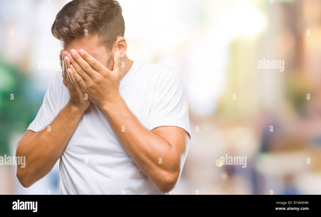 Young handsome man over isolated background with sad expression ...