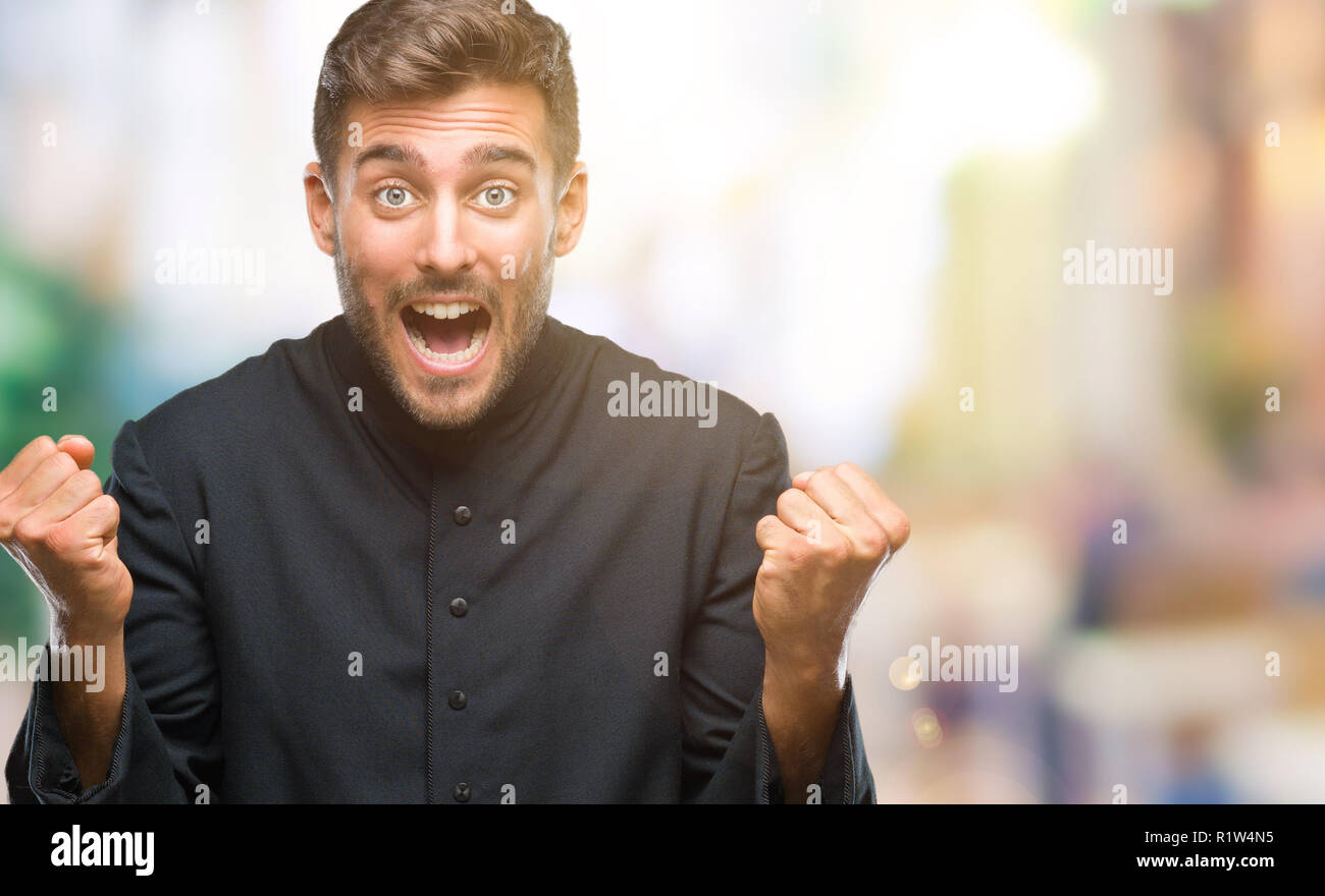 Young catholic christian priest man over isolated background ...
