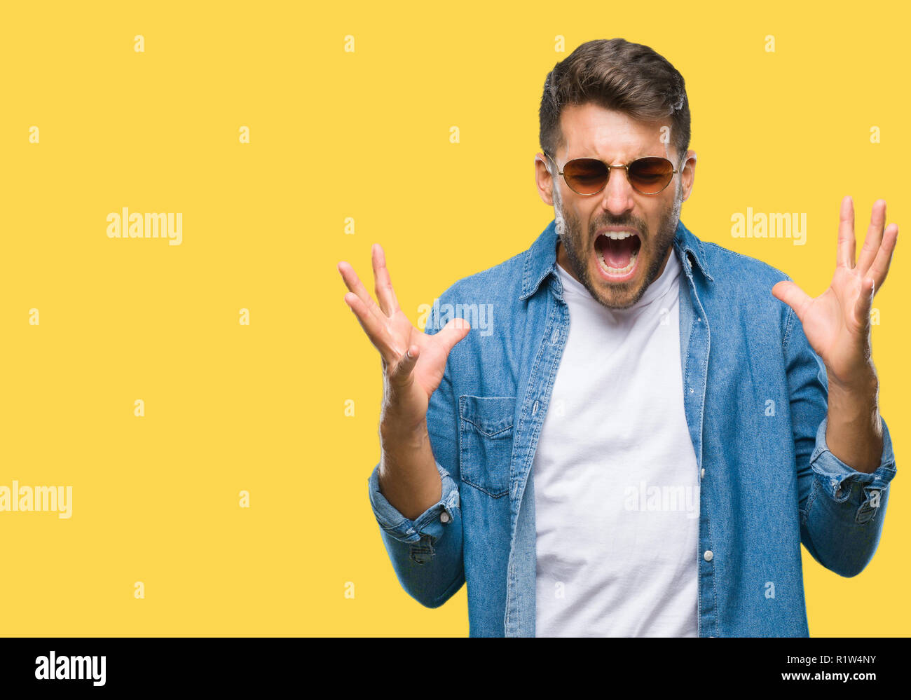 Young handsome man wearing sunglasses over isolated background ...